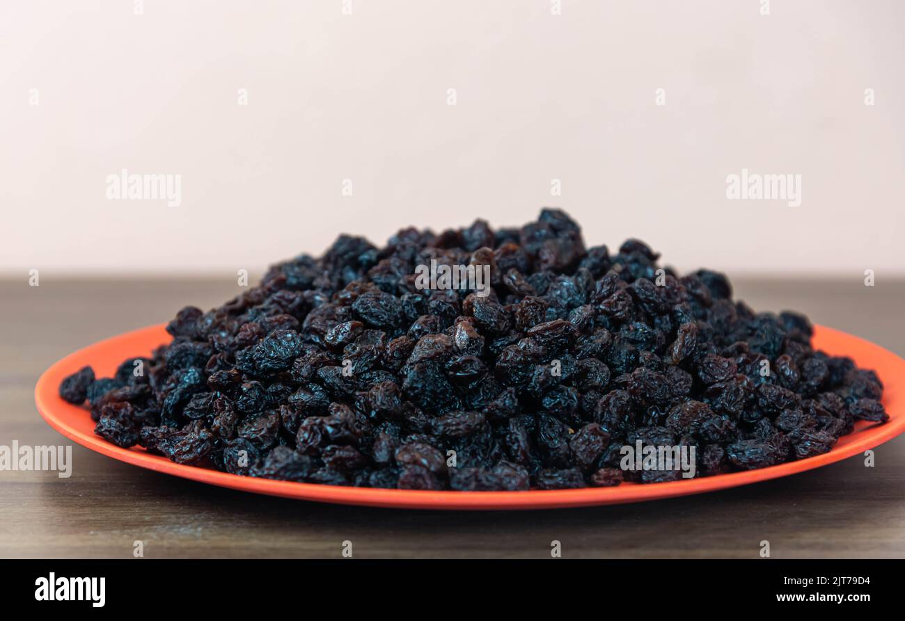 Dried black raisins. Raisins are obtained by dehydrating fresh grapes ...