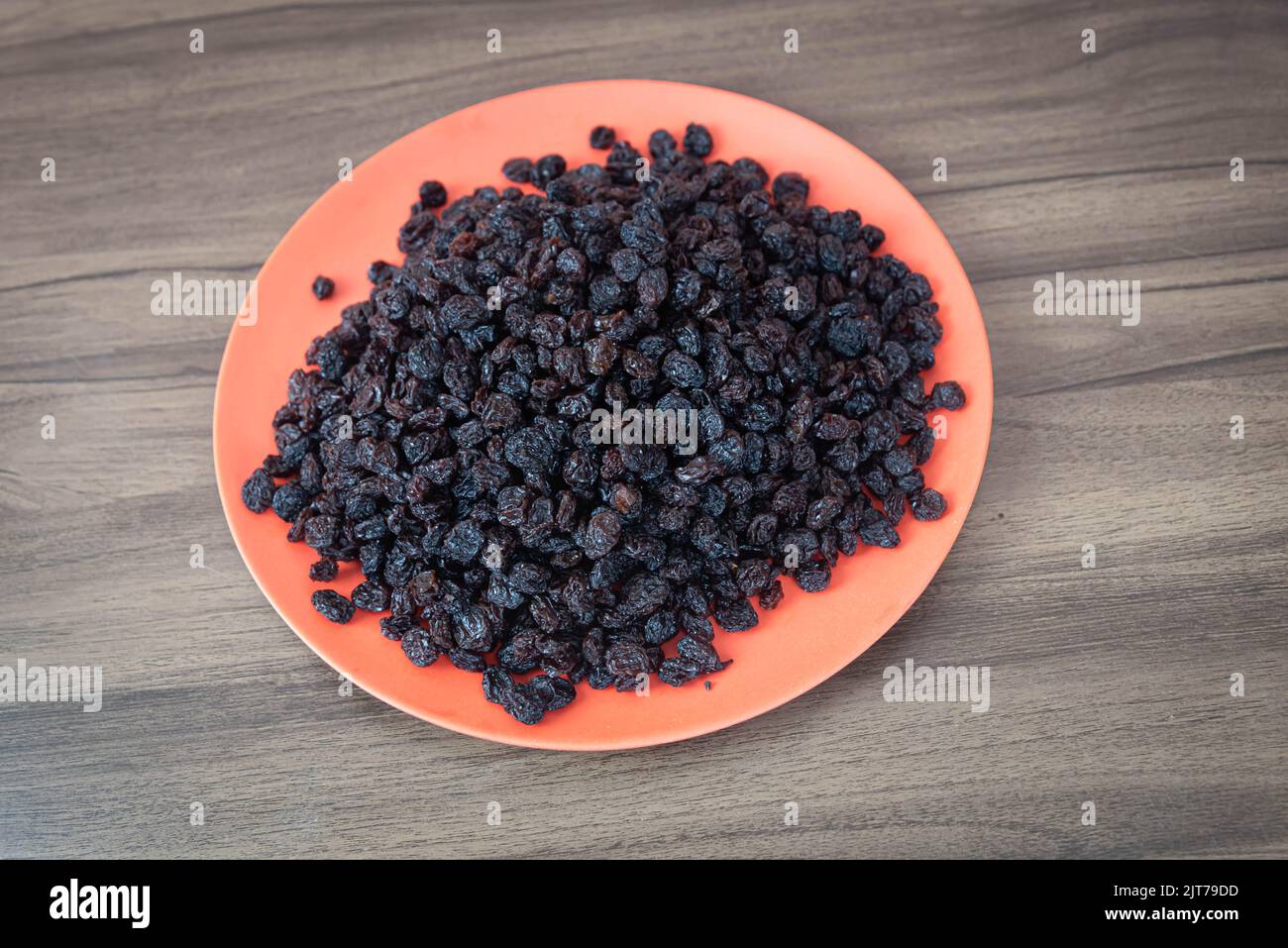 Dried black raisins. Raisins are obtained by dehydrating fresh grapes ...