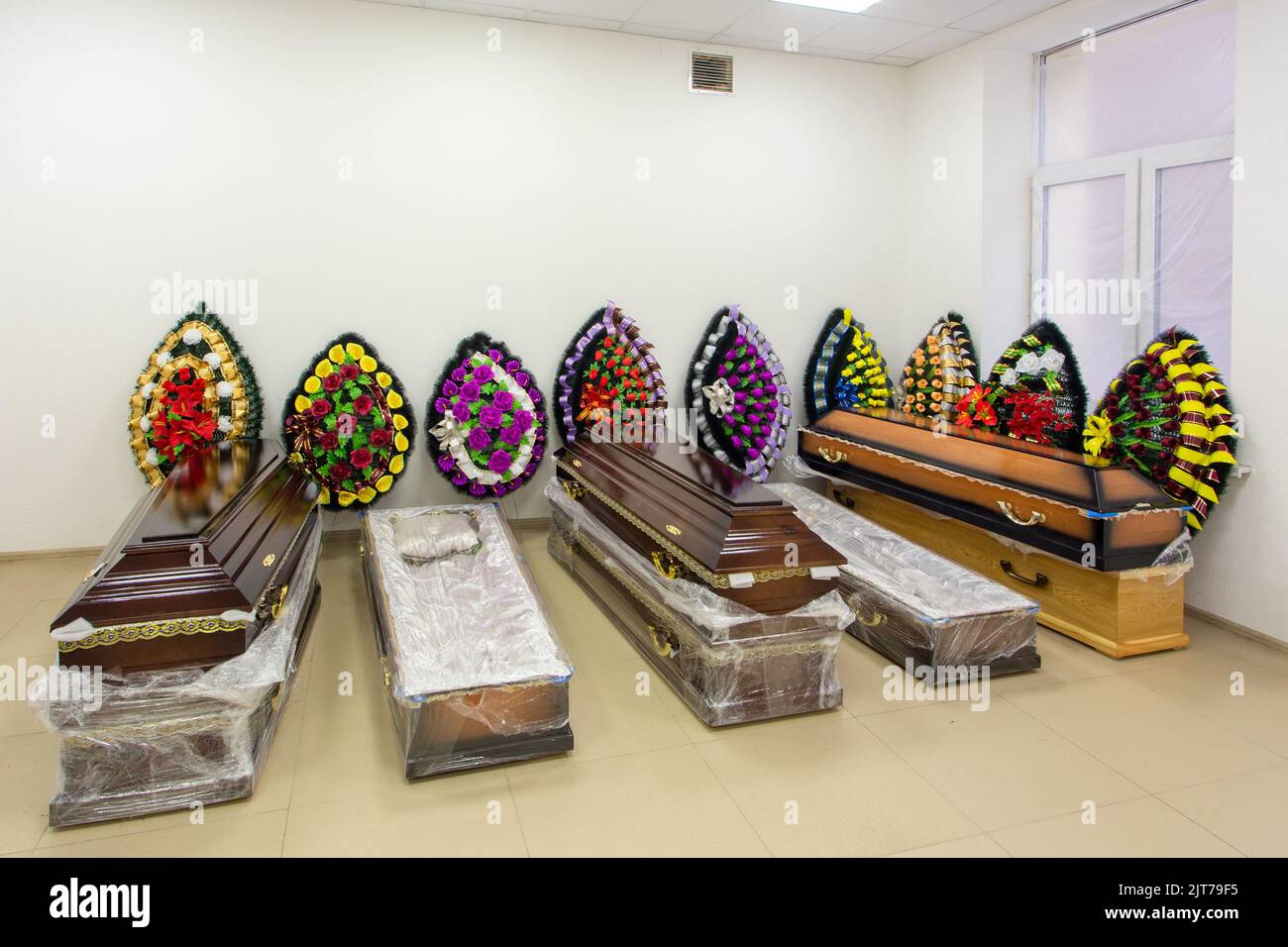 Interior of room with funeral accessories. Shop selling coffins ...