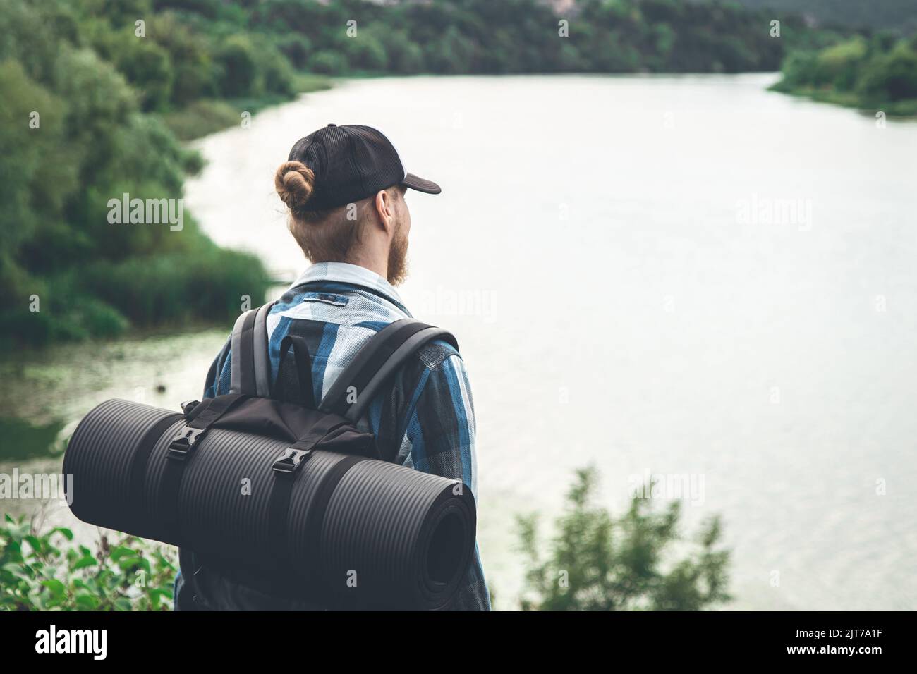 Male traveler with backpack and karimat in nature, back view Stock ...