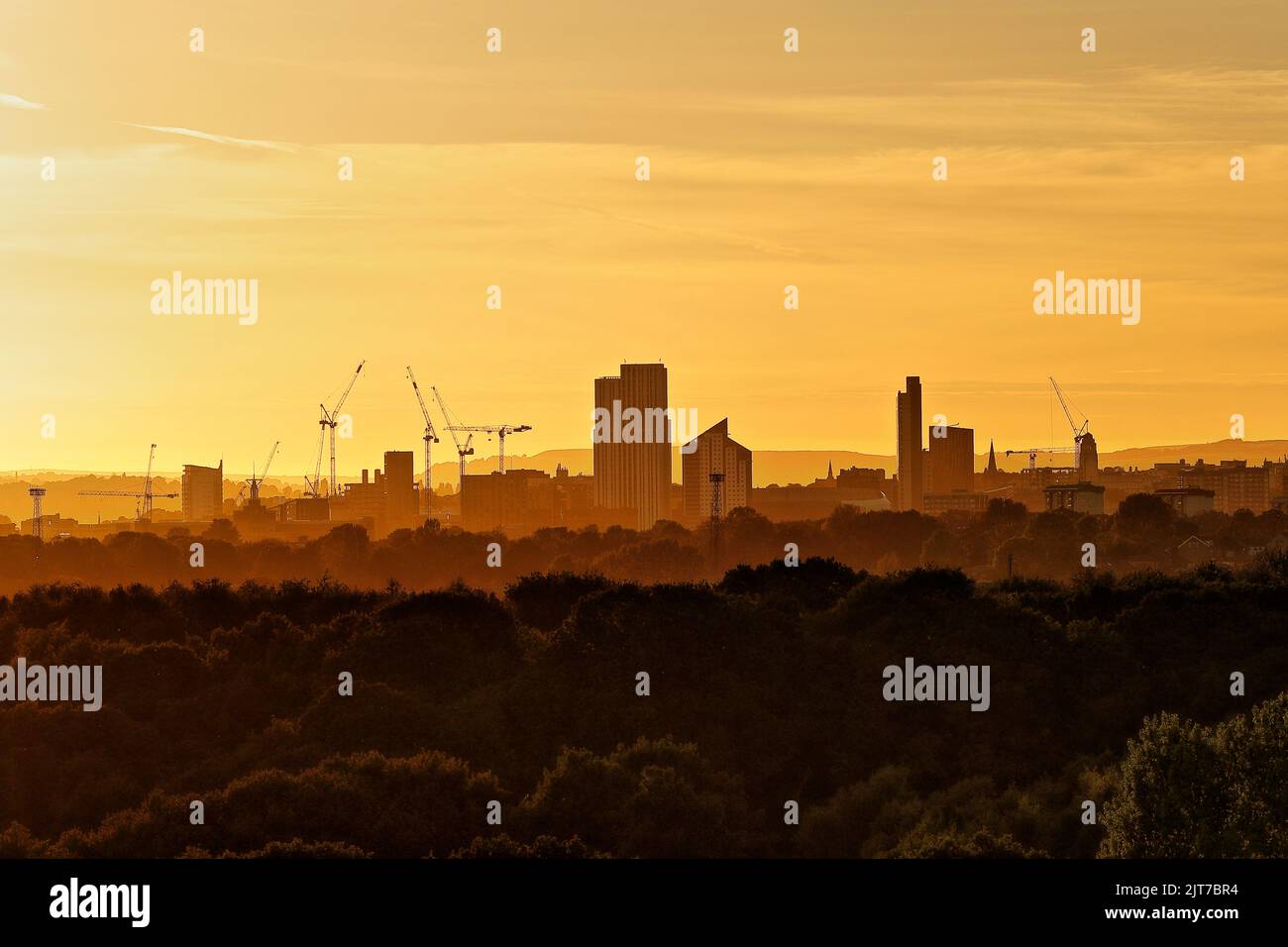 Leeds City Centre skyline silhouetted against a sunset. This view was ...