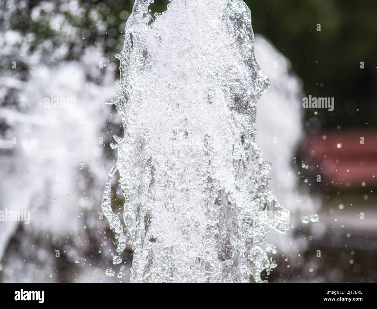 Water splashes from fountain on dark background. Natural texture of ...
