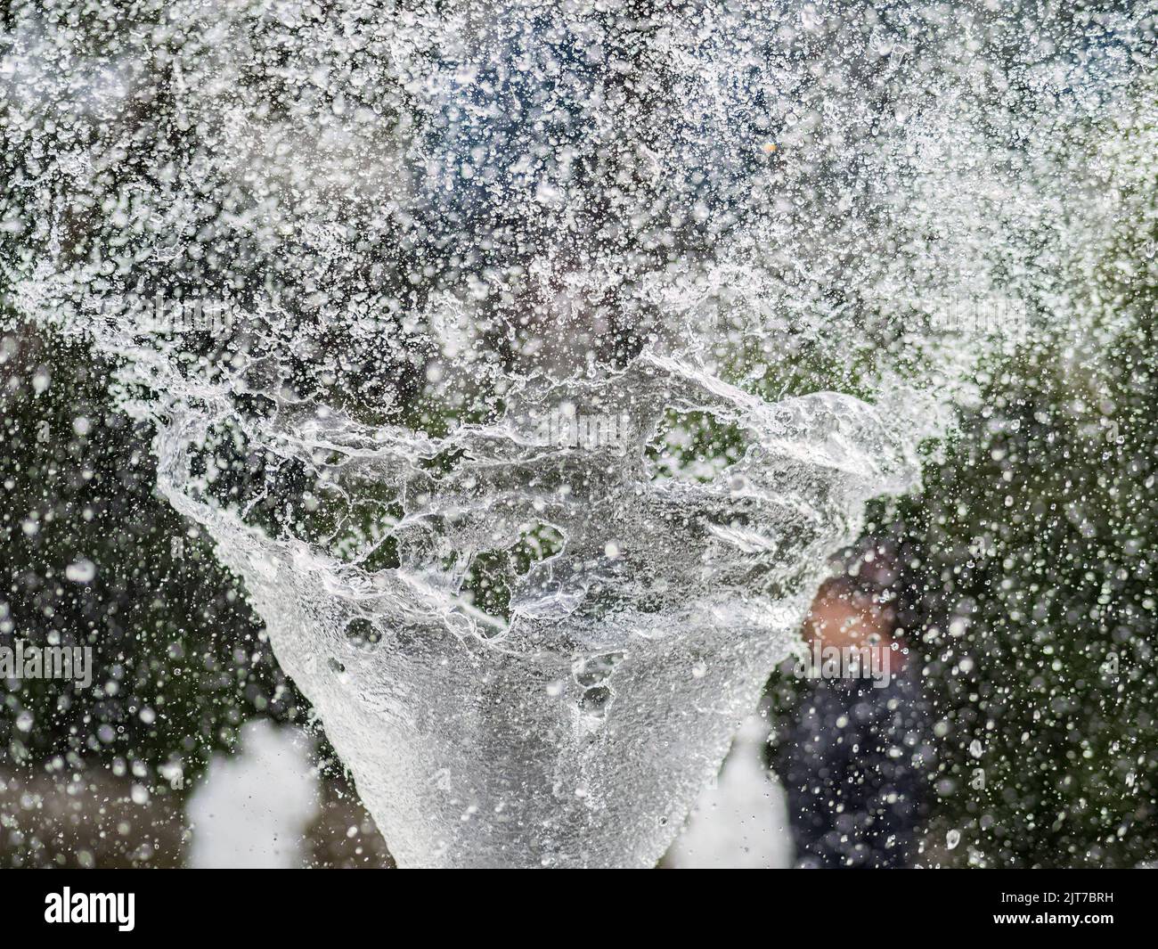 Water splashes from fountain on dark background. Natural texture of ...
