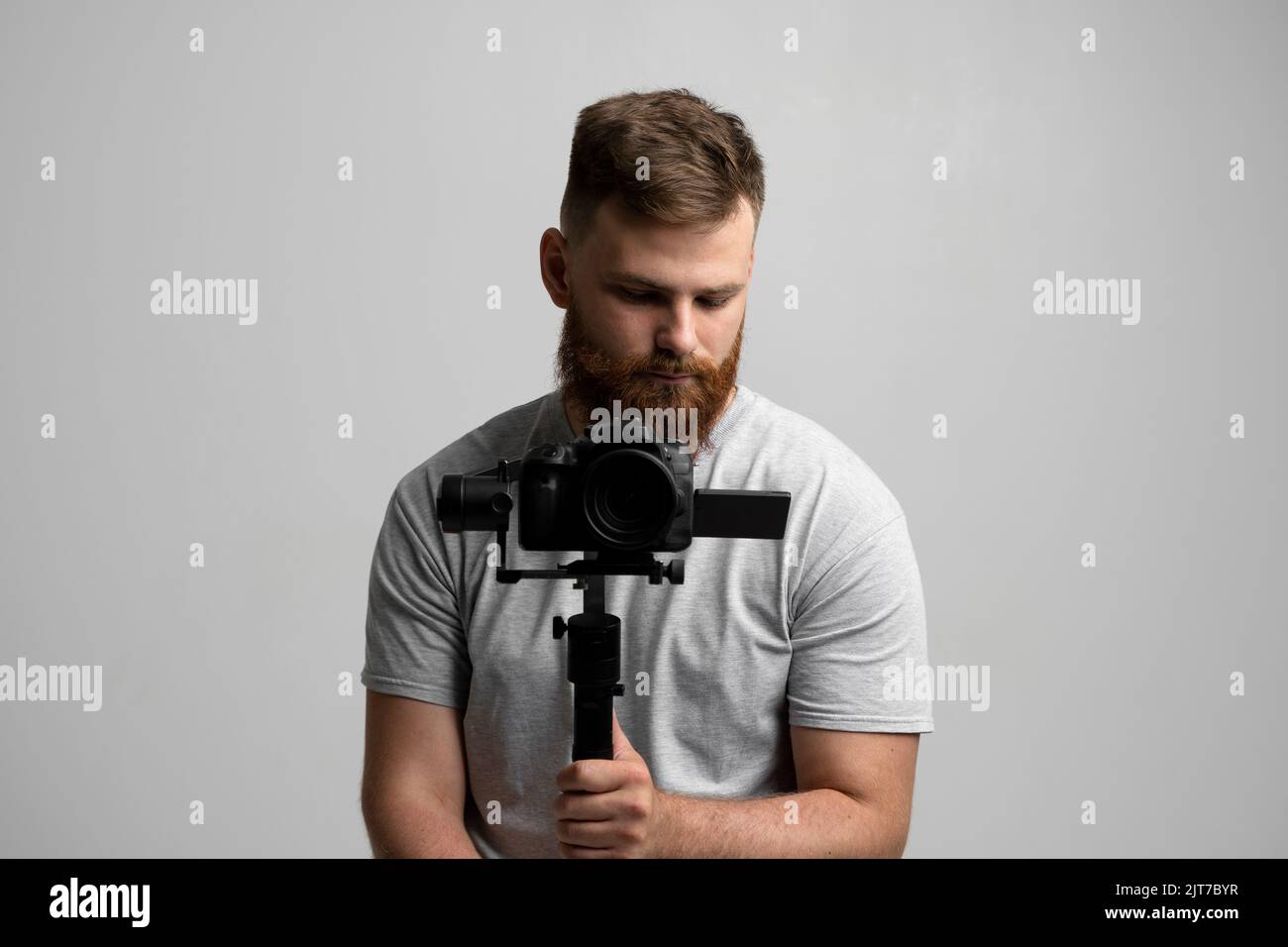 Professional filmmaker with a dslr camera on 3-axis gimbal stabilizer ...