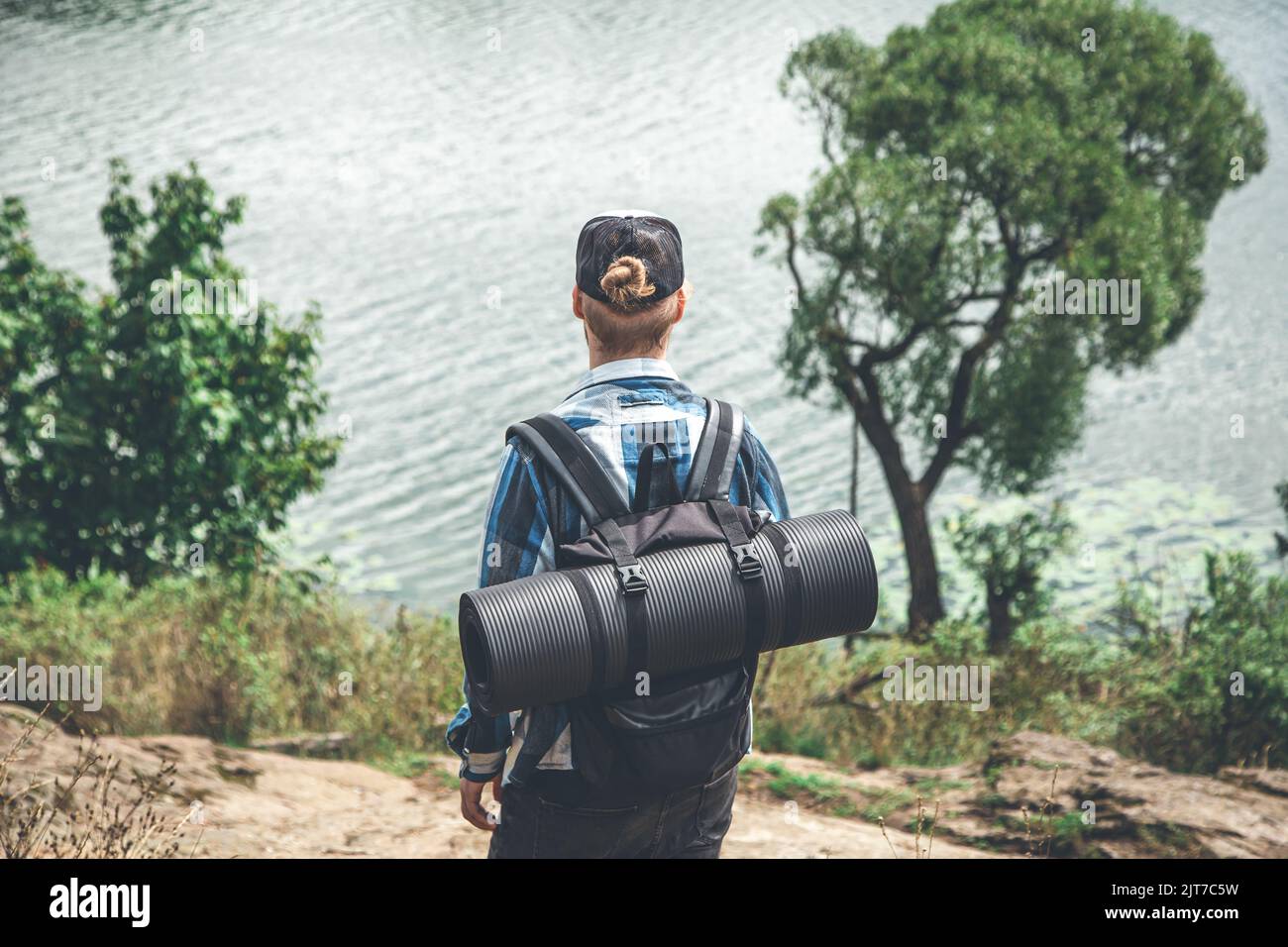 Male traveler with backpack and karimat in nature, back view Stock ...