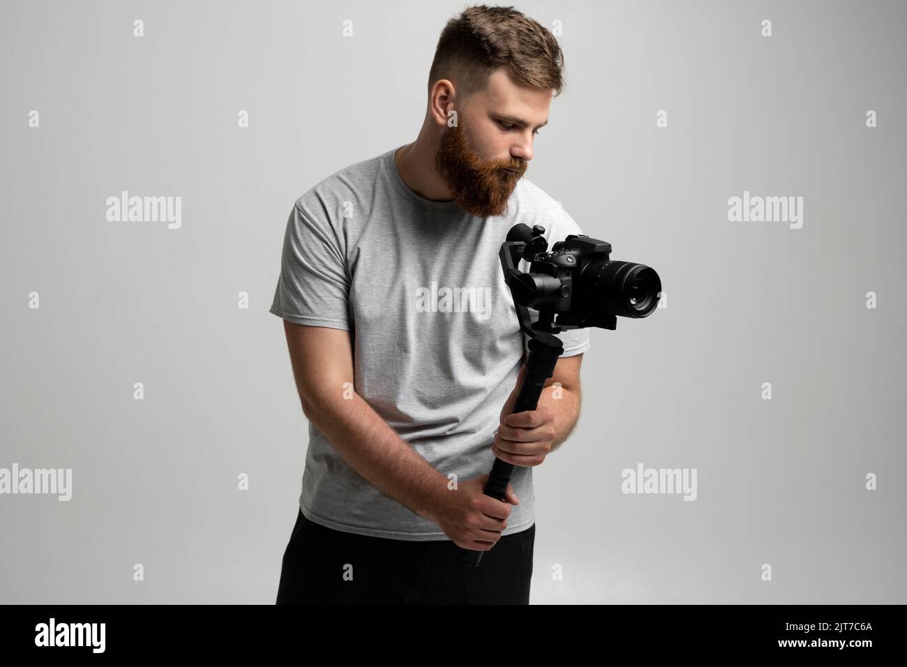 Professional content creator with a dslr camera on 3-axis gimbal ...