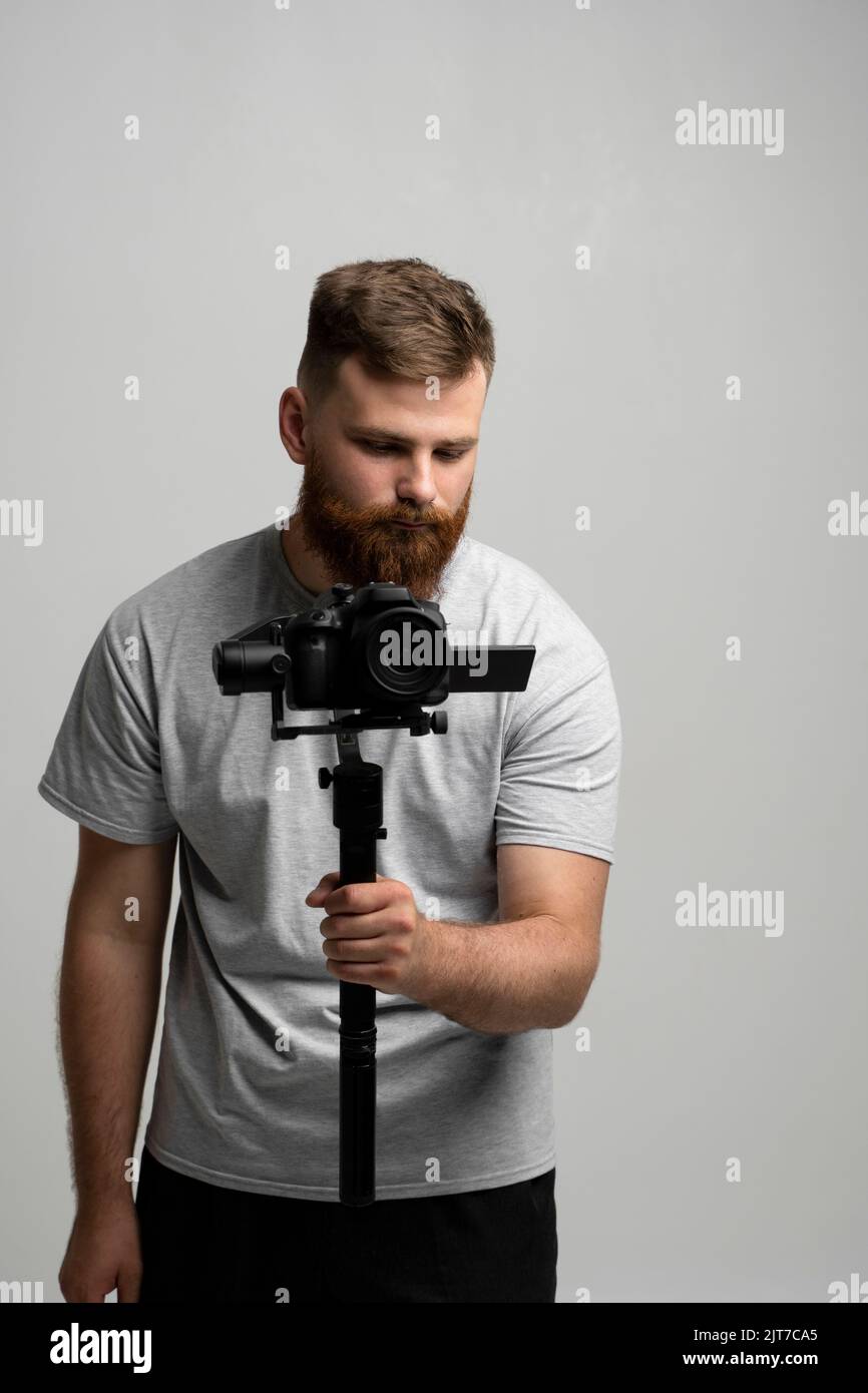 Professional video operator with a dslr camera on 3-axis gimbal ...