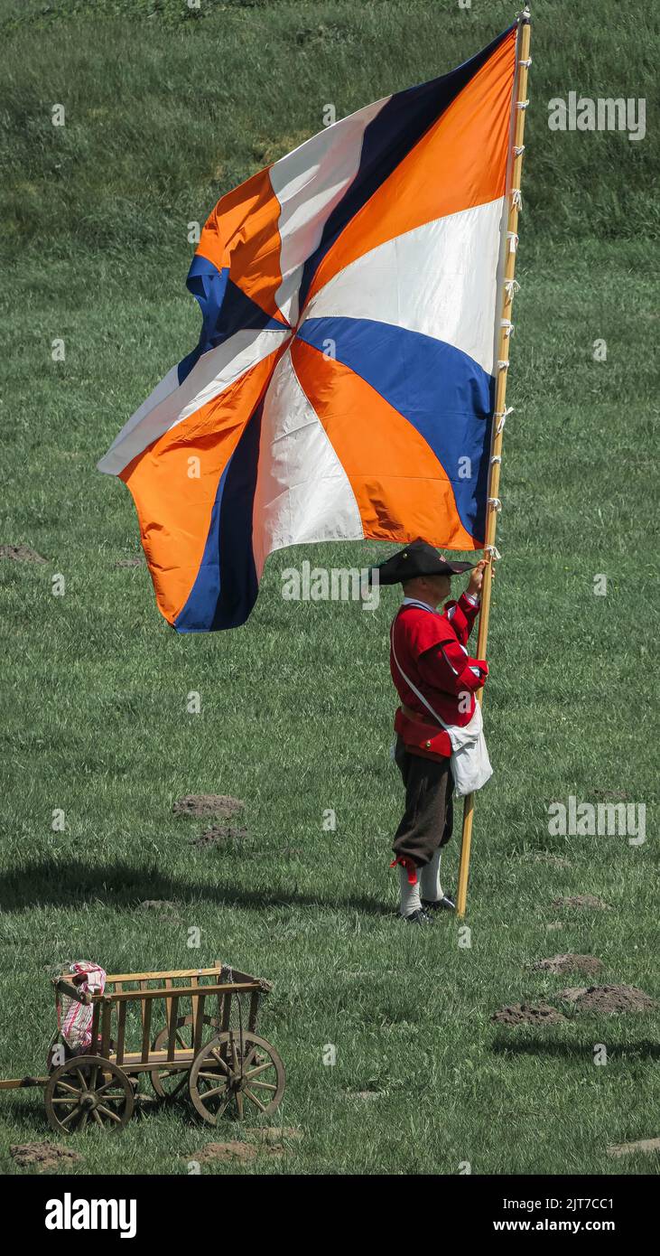 A vertical shot of the soldier with an old Dutch flag in The ...