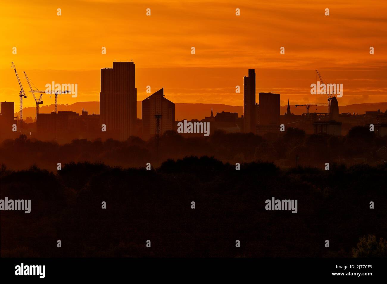 Leeds City Centre skyline silhouetted against a sunset. This view was ...