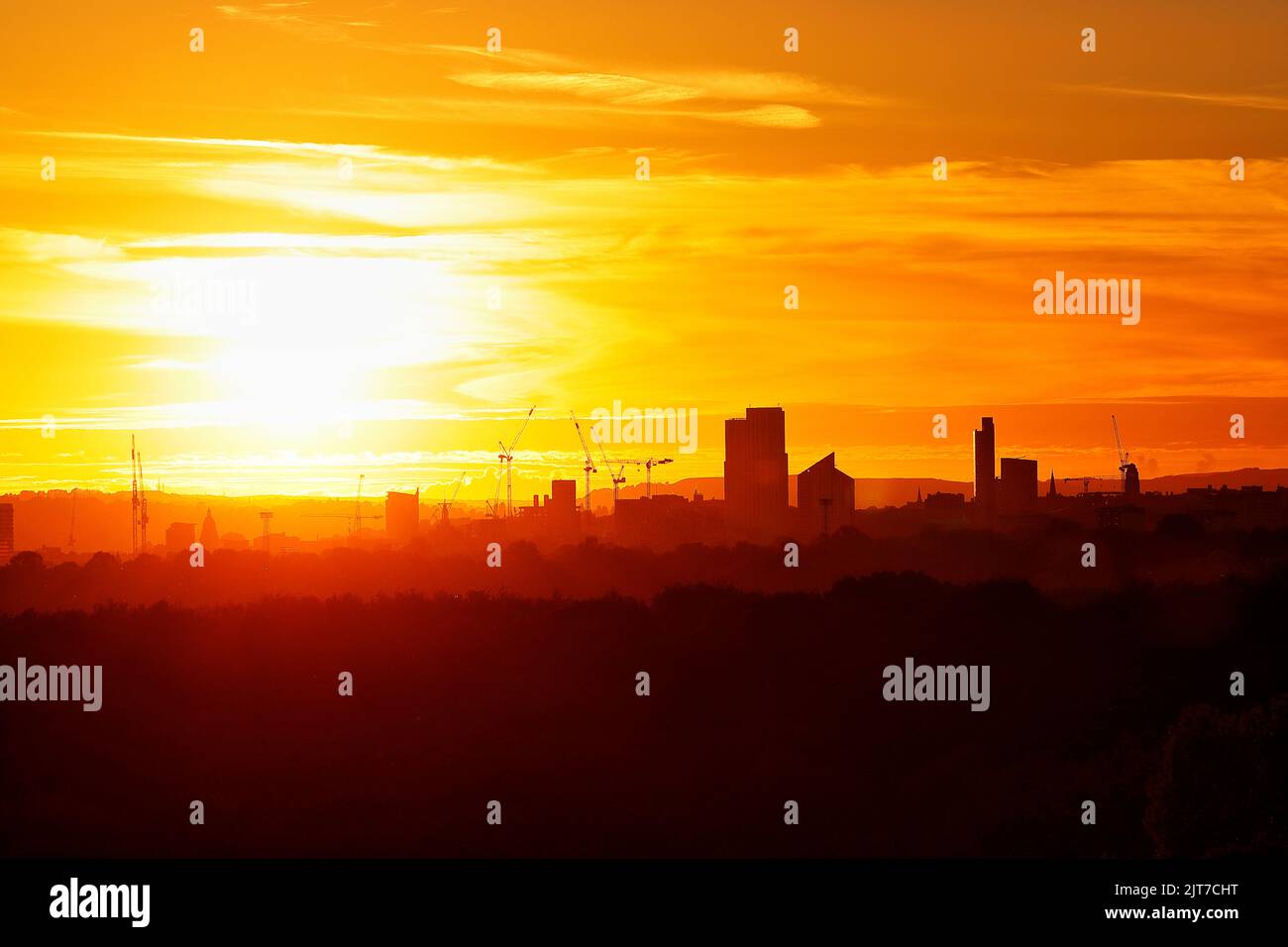 Leeds City Centre skyline silhouetted against a sunset. This view was ...