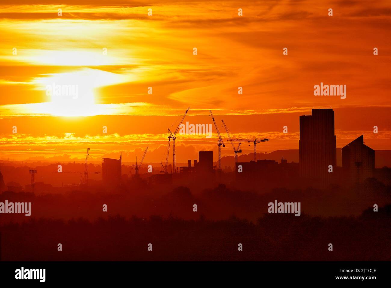 Leeds City Centre skyline silhouetted against a sunset. This view was ...