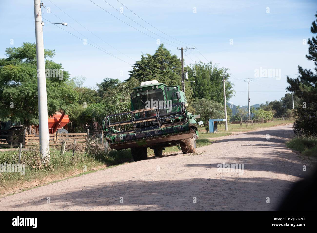 Harvesting machine parked on dirt road. Agricultural production ...