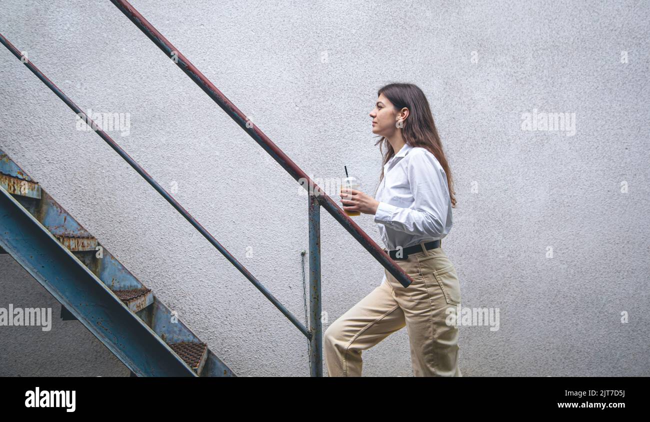 Business young woman near the stairs with a cup of coffee Stock Photo ...