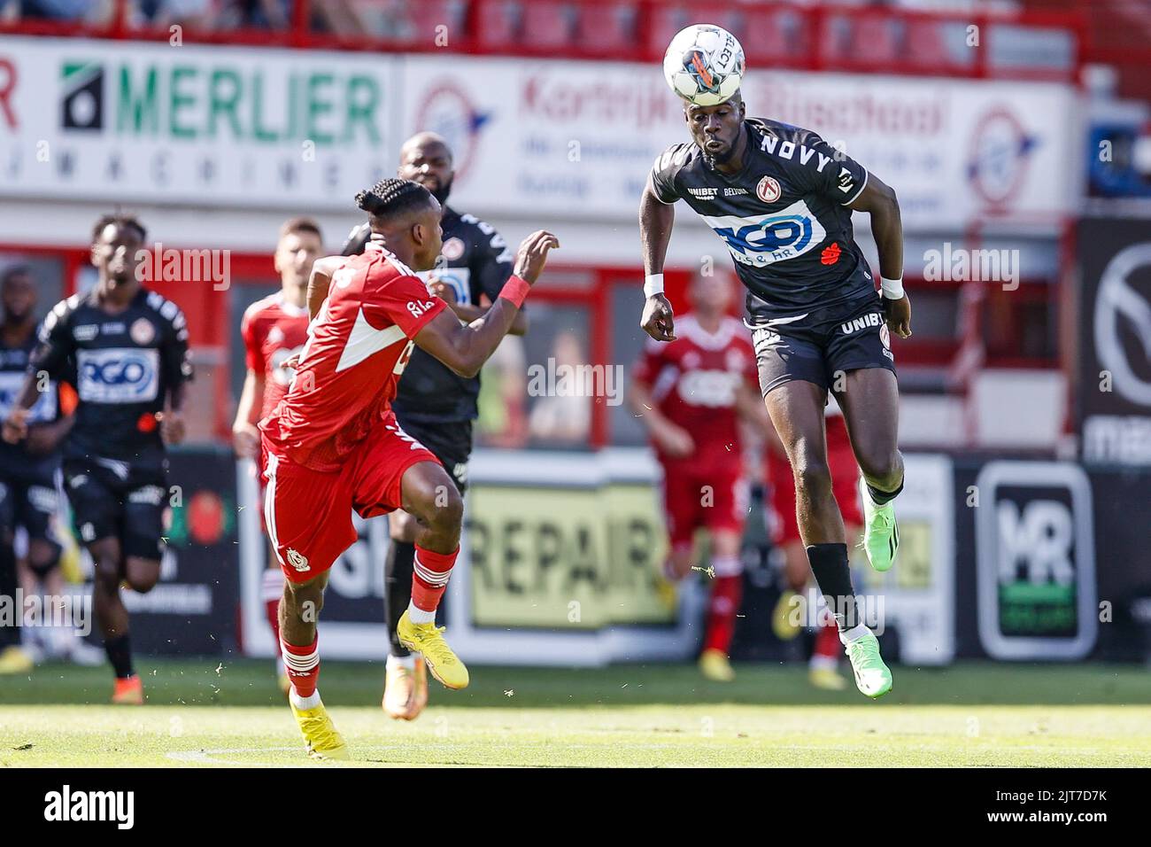 Kortrijk, Belgium. 28th Aug, 2022. Standard's Nathan Ngoy and Kortrijk's Pape Habib Gueye fight ...