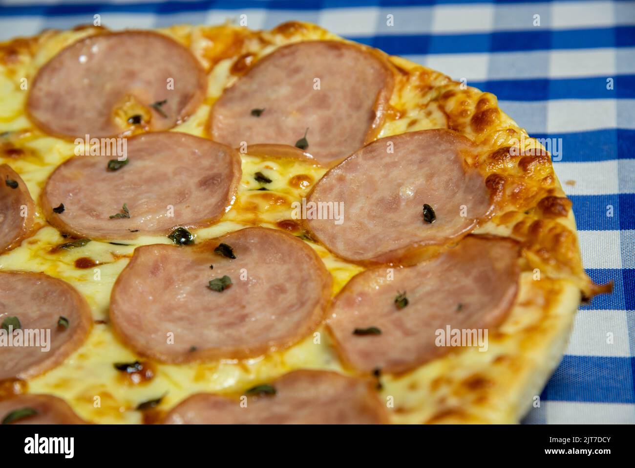 Homemade cheese and loin pizza. Pizza is a dish of Italian origin, but ...