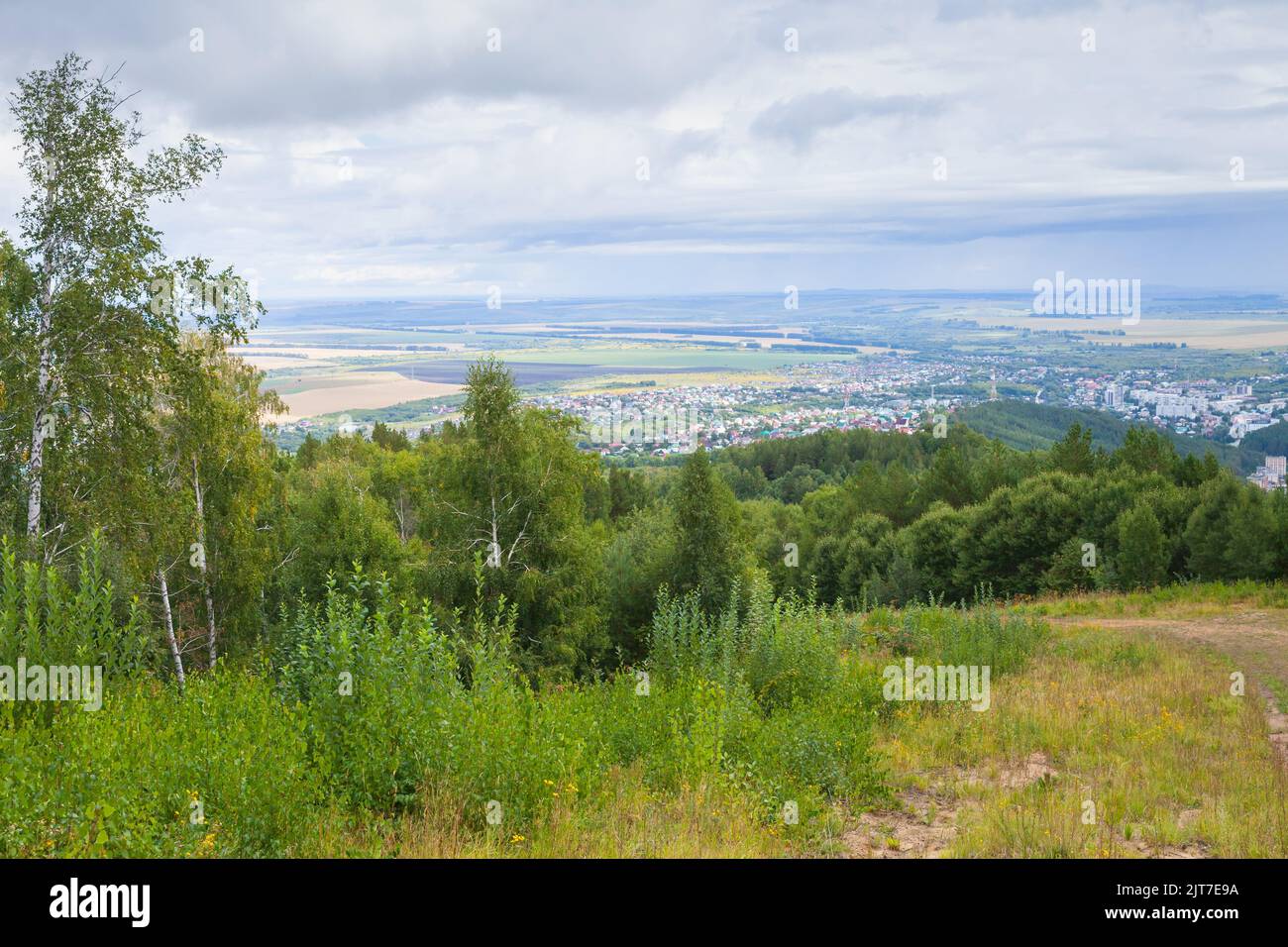 Mount Tserkovka view. Rural Russian landscape with Belokurikha town on ...