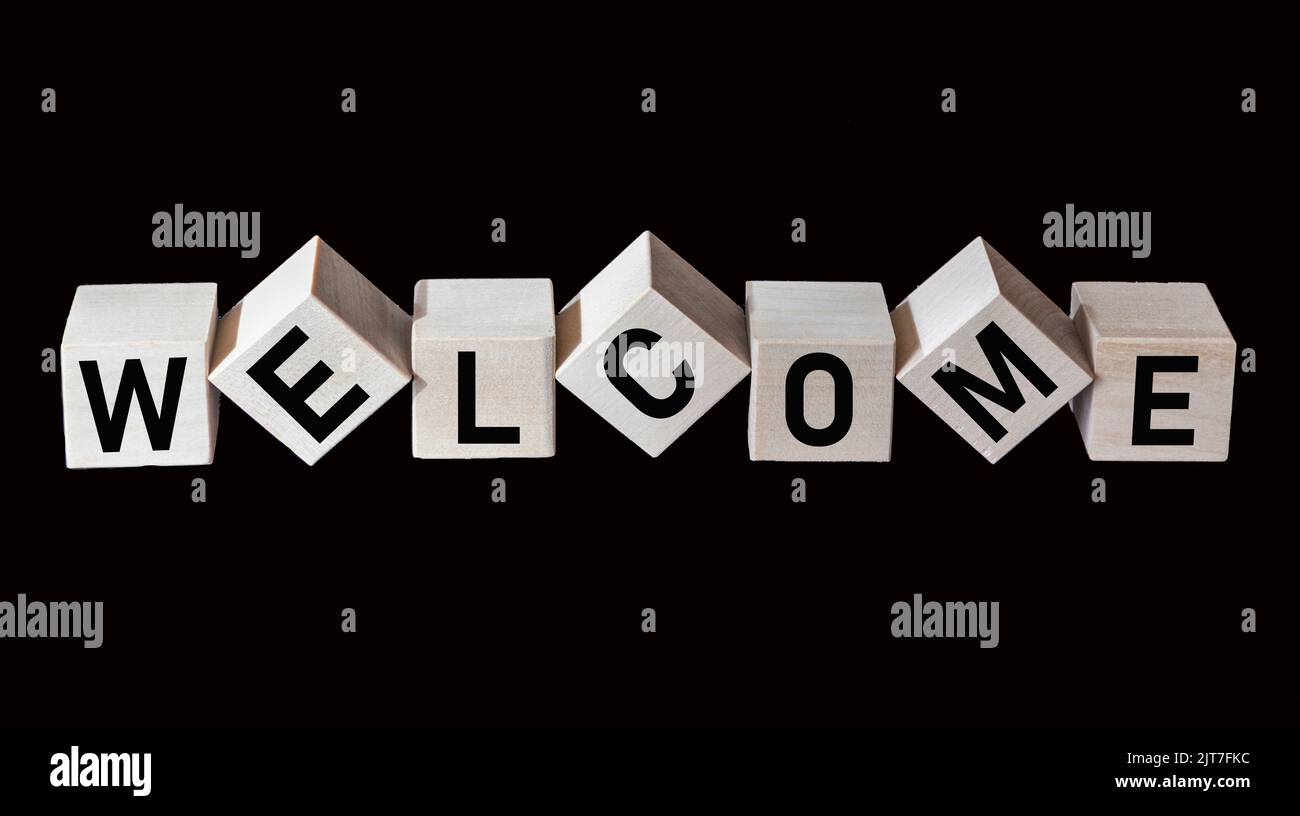 Symbol of welcome and support. Concept welcome on wooden blocks. Black ...