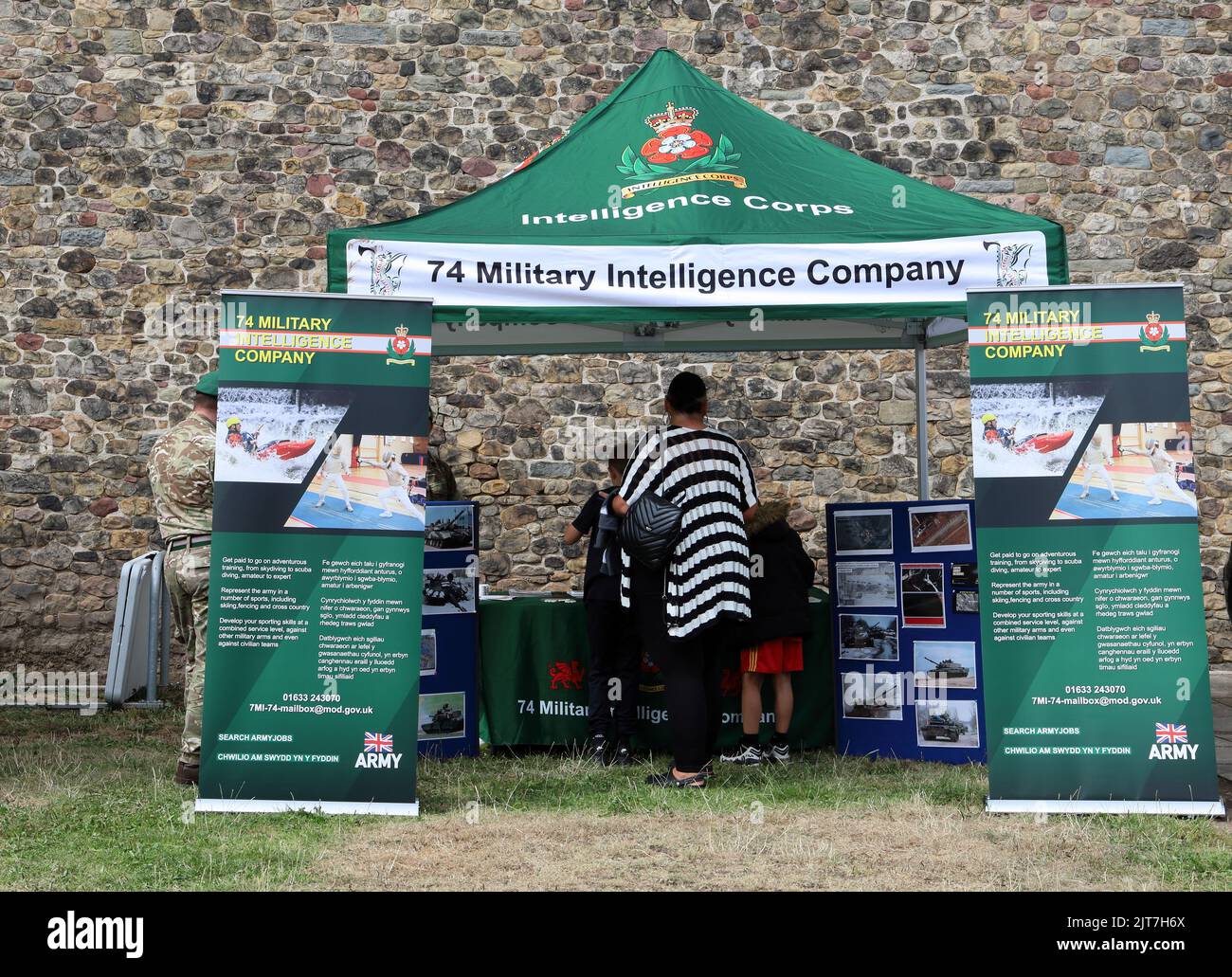 Woman talks to soldiers at 74th Military Intelligence Company. Armed Forces recruitment tents at ...