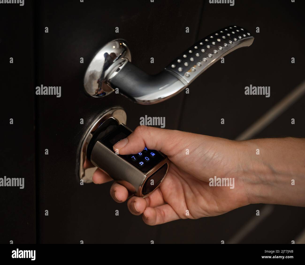 Woman opens the combination lock on the door to the apartment. Keyless ...