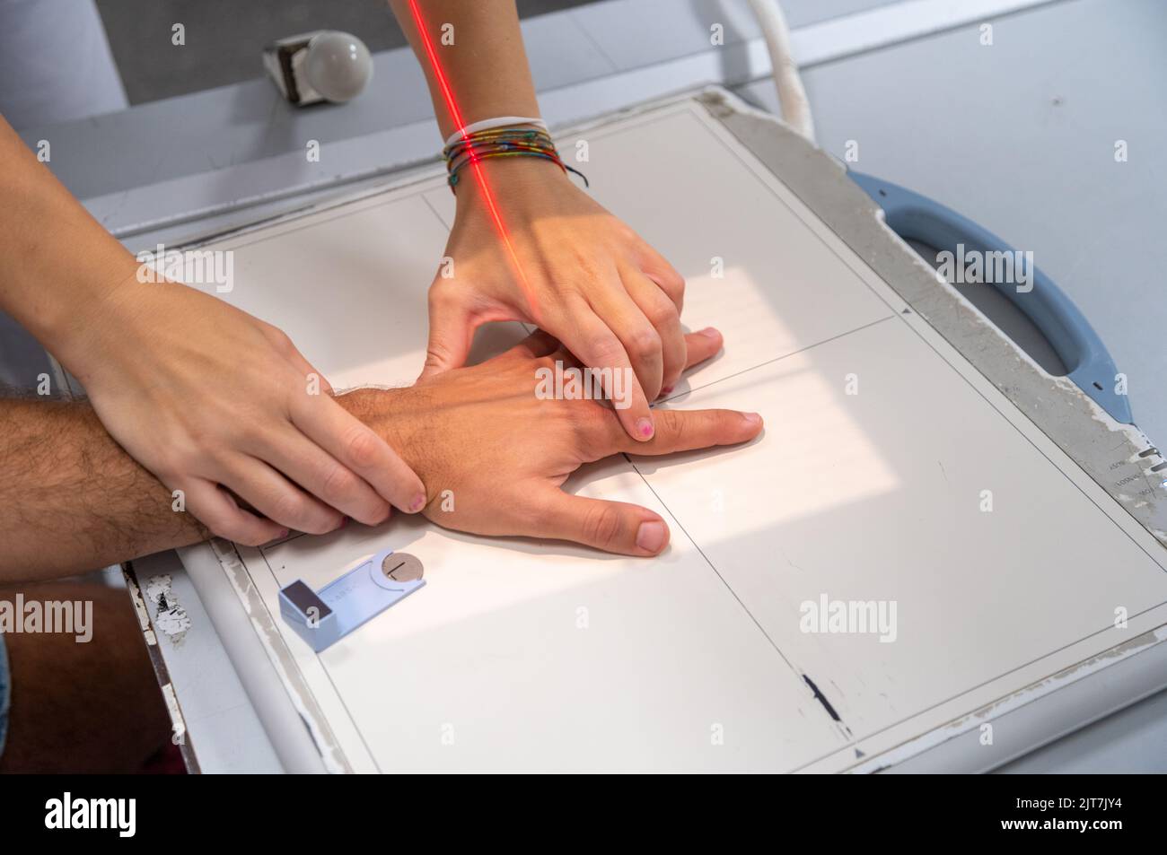 A hand x ray session ongloing in a radiology session Stock Photo - Alamy