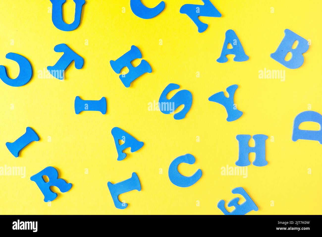 Colored letters of the alphabet on a yellow background. Educational ...
