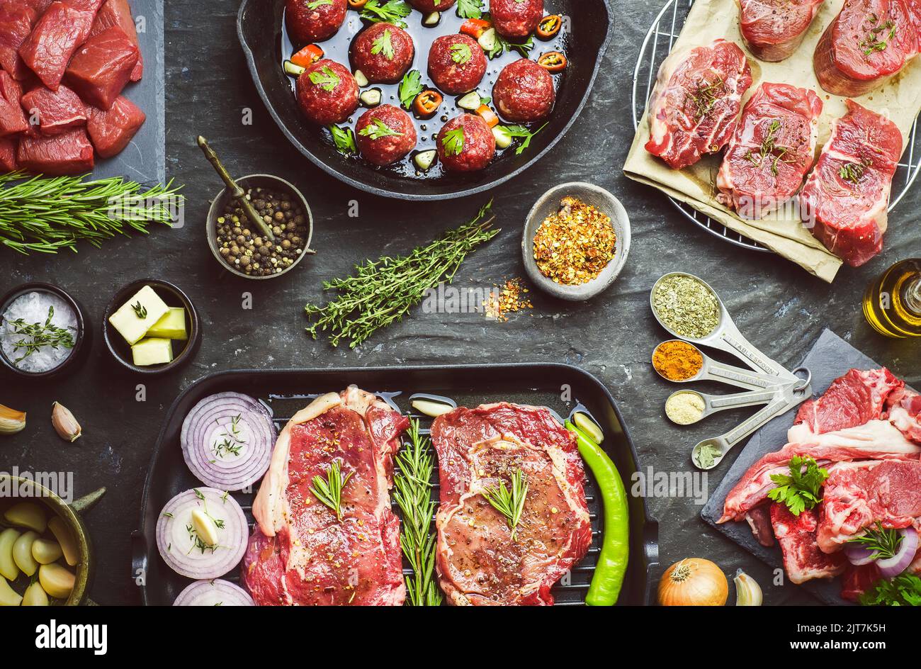 Different types of fresh raw meat sprinkled with seasonings and placed ...