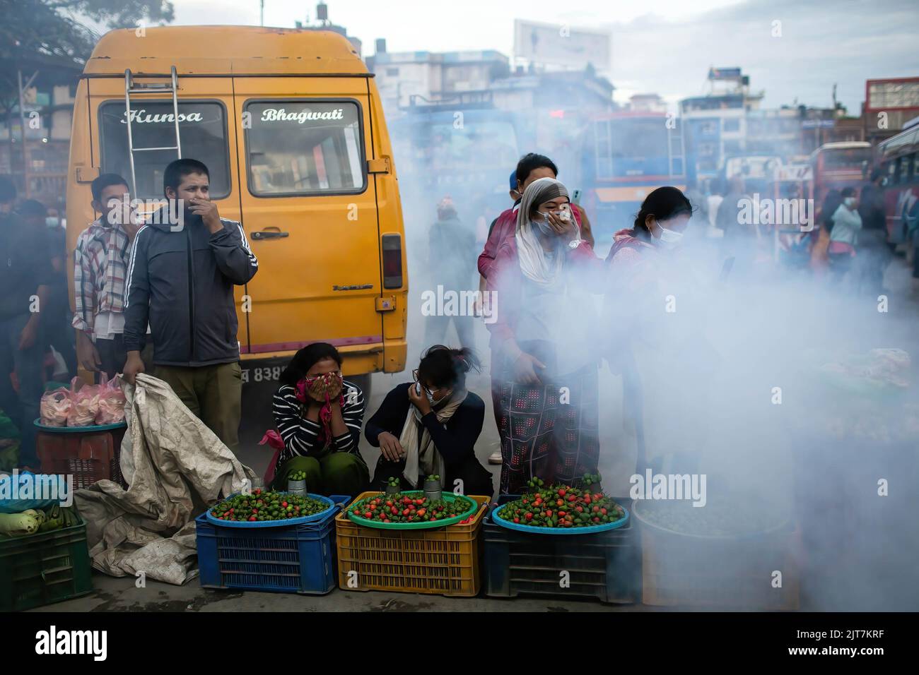 People cover themselves from smoke spread to control dengue in Lalitpur ...