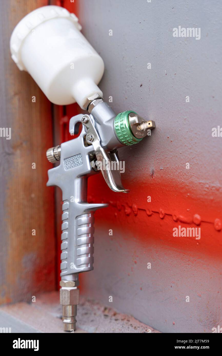 Paint spray gun for painting on a gray background Stock Photo - Alamy