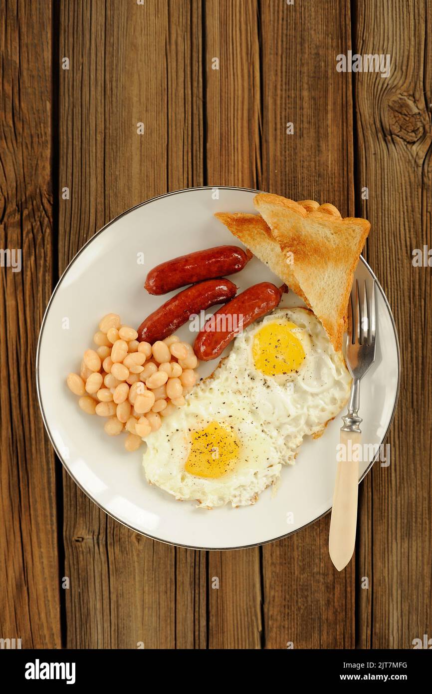 Full english breakfast with eggs, sausages, beans, toasts overhead ...