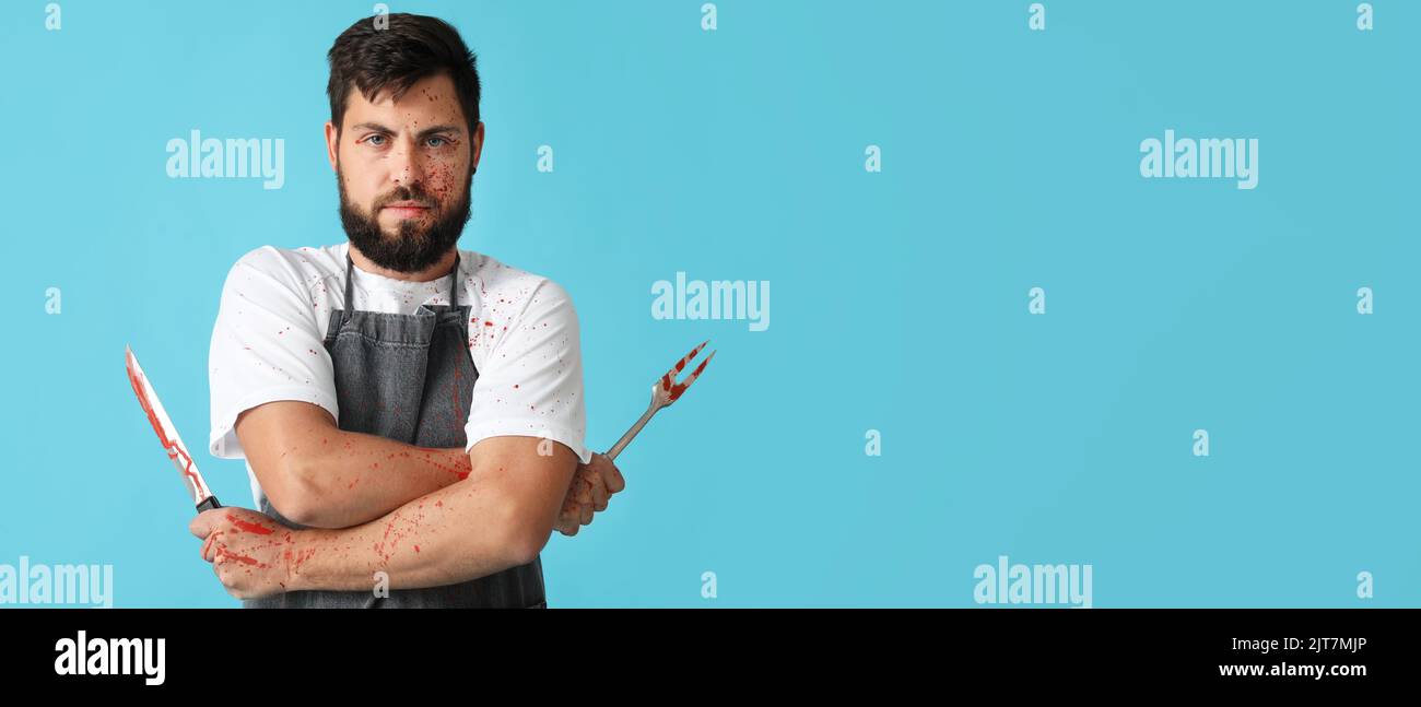 Man dressed as butcher for Halloween on blue background with space for ...