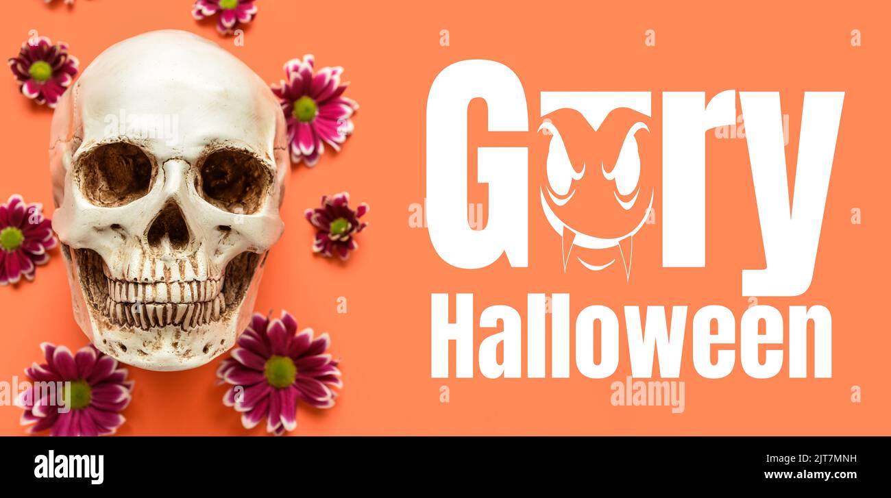 Human skull with beautiful flowers on orange background. Gory Halloween ...