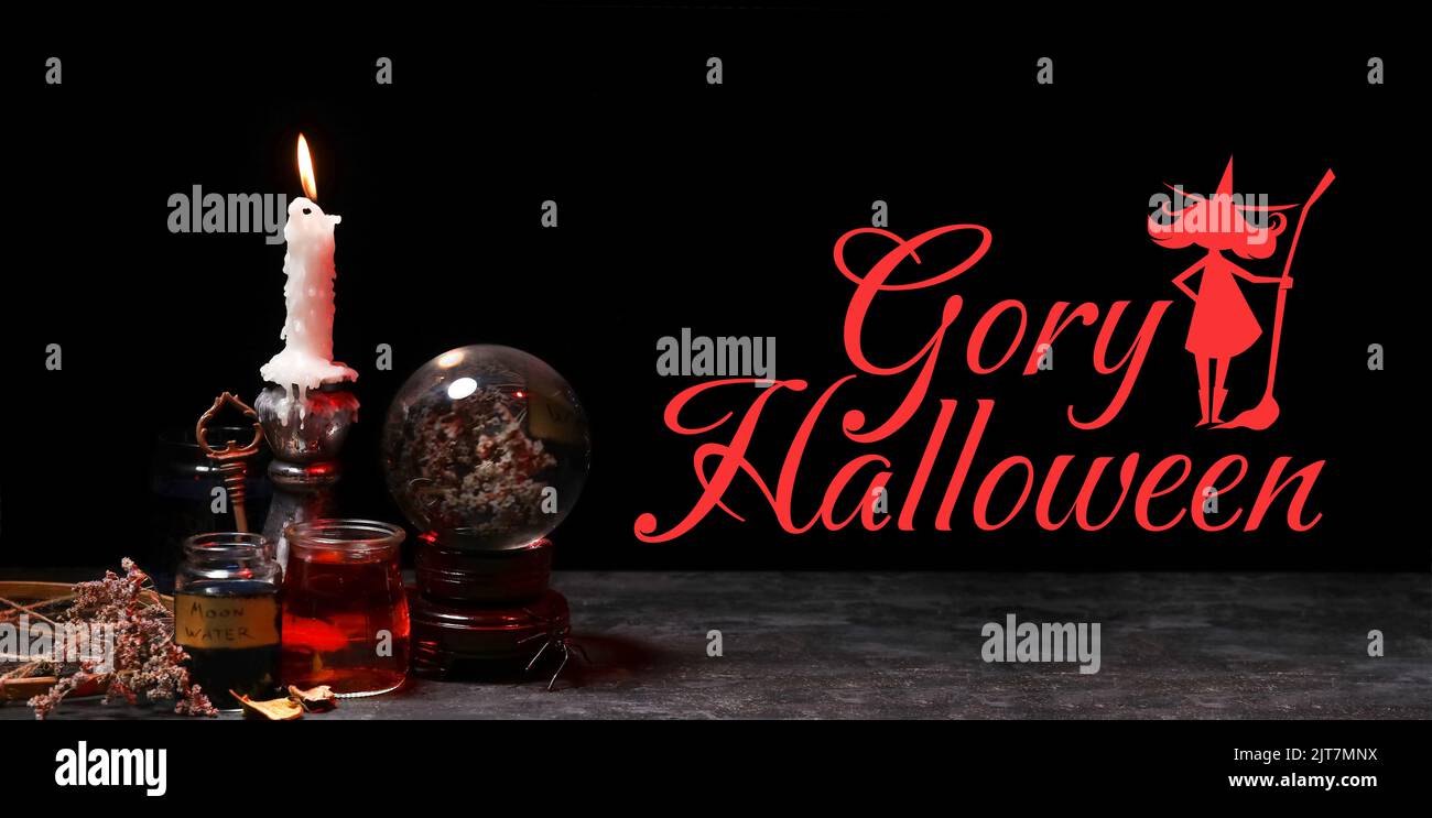 Burning candle, jars with potion and crystal ball on dark background ...