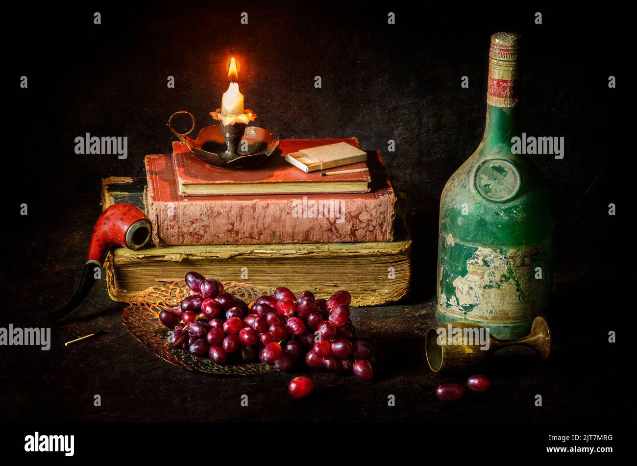 Classic still life with fresh delicious grapes placed with vintage wine ...