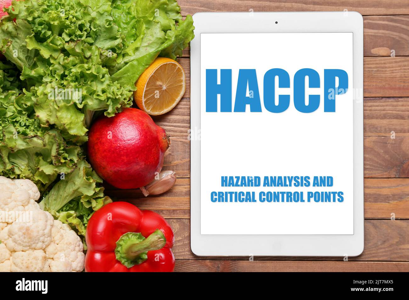 Tablet computer with text HAZARD ANALYSIS AND CRITICAL POINTS and fresh ...