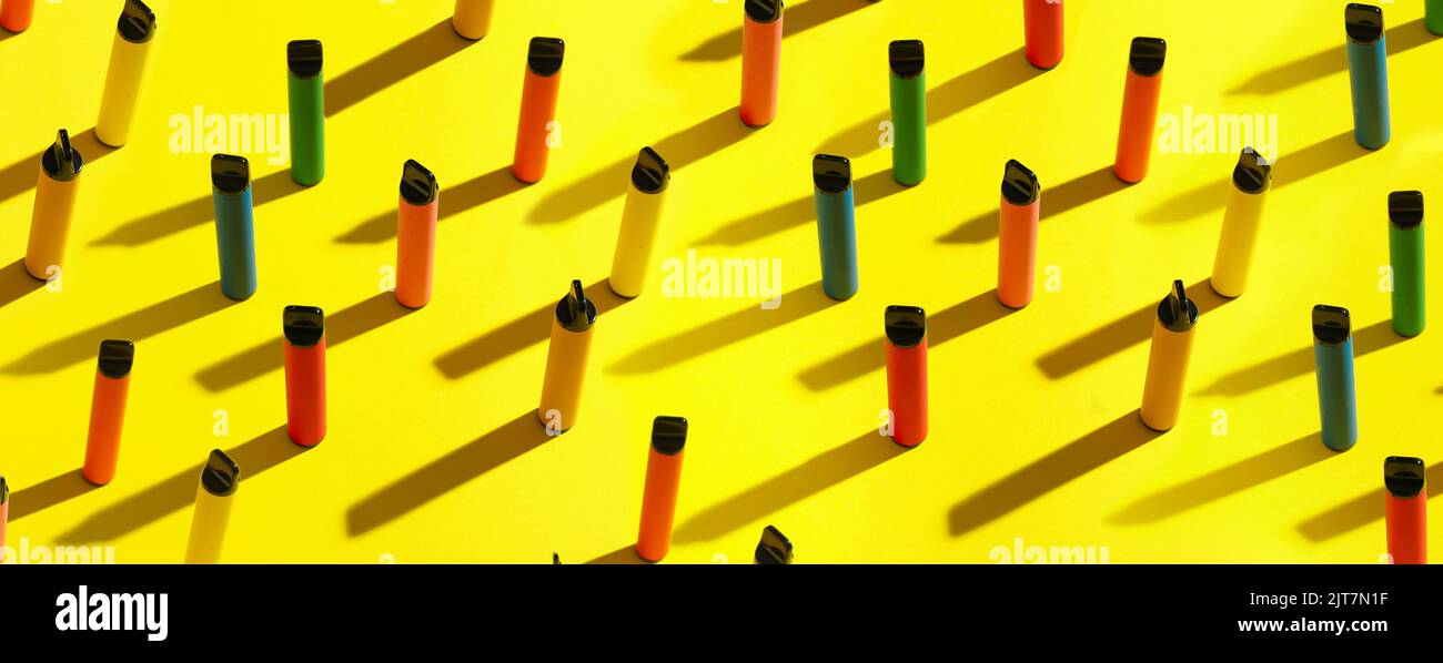 Many electronic cigarettes on yellow background Stock Photo - Alamy