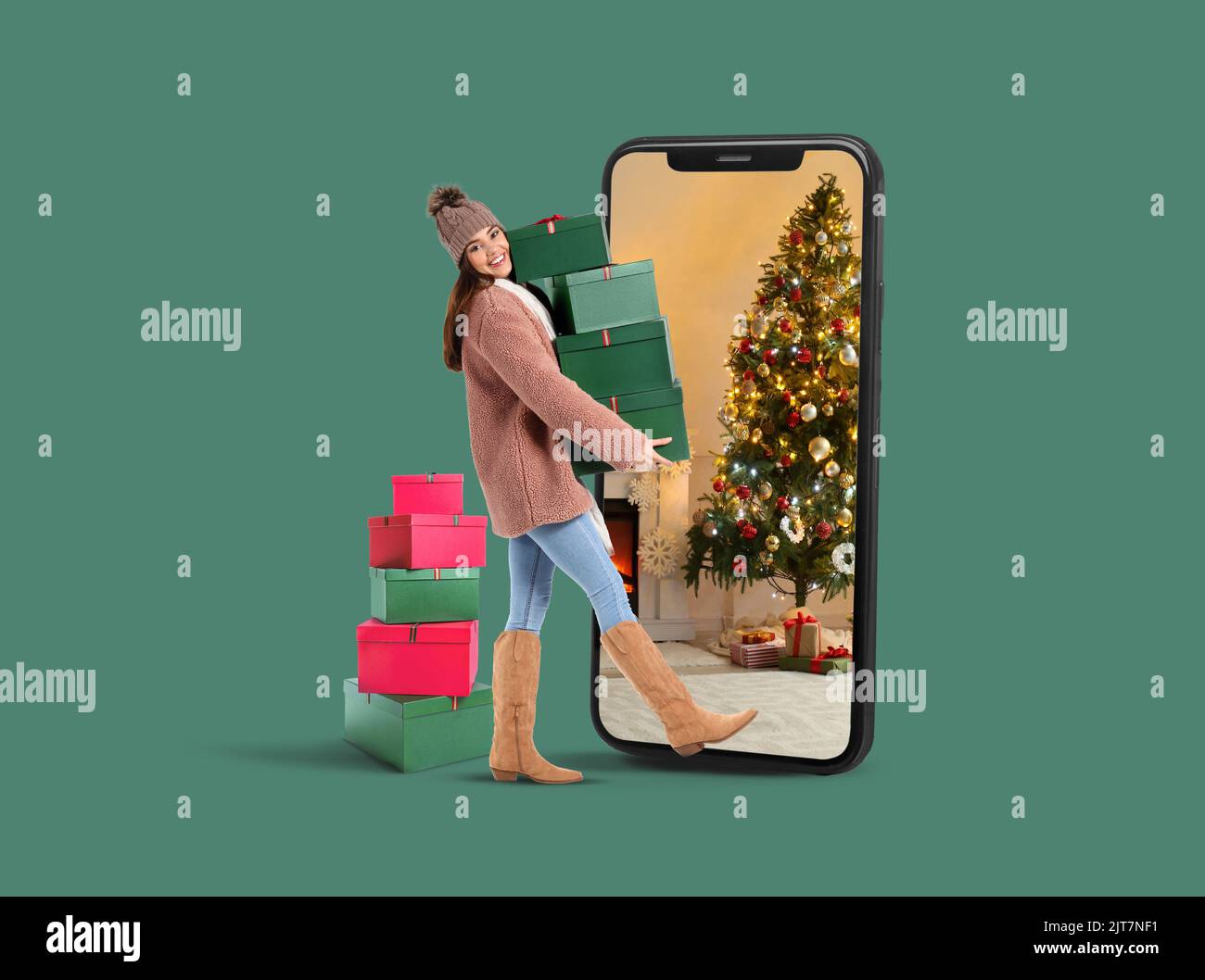 Going young woman with Christmas gifts and big mobile phone with ...