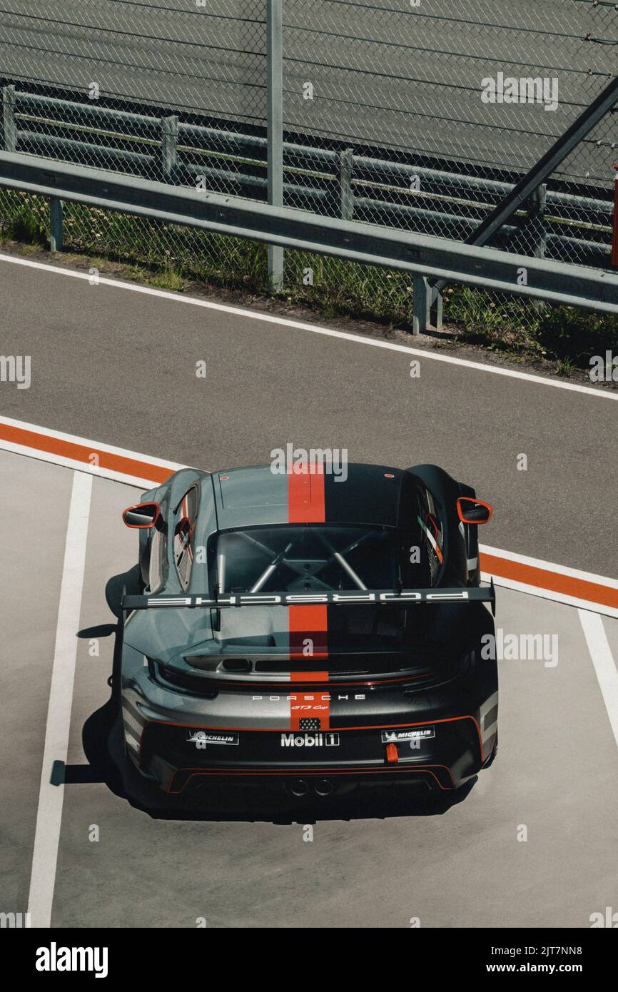 A vertical shot of a Porsche car on a race track in Leipzig, Germany ...