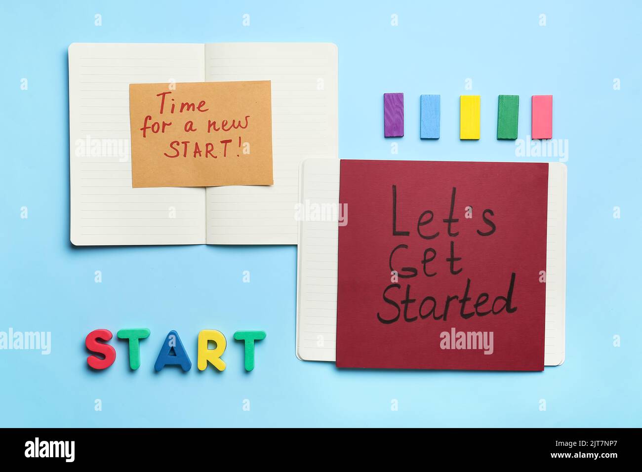 Paper sheets with text TIME FOR A NEW START and LET'S GET STARTED with ...