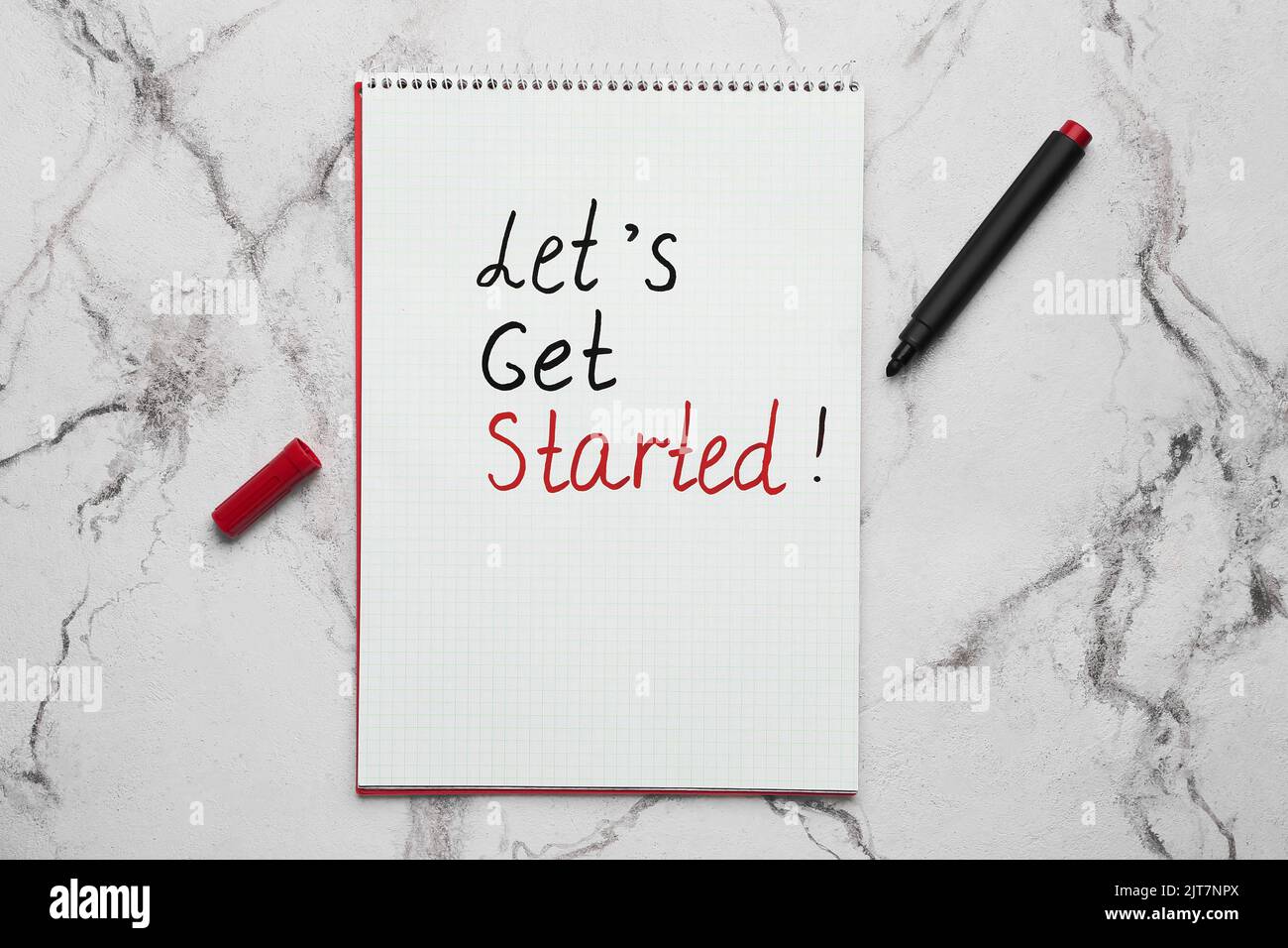 Notebook with text LET'S GET STARTED and marker on white background ...