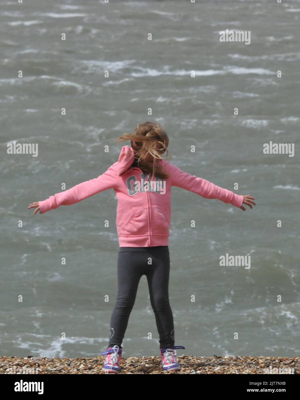 A GIRL ON THE BEACH DURING THE GALE FORCE WINDS ON THE SEAFRONT AT ...