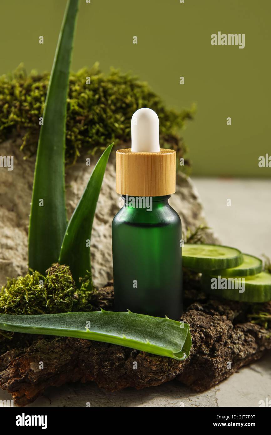 Composition with bottle of essential oil, aloe vera leaves and tree ...