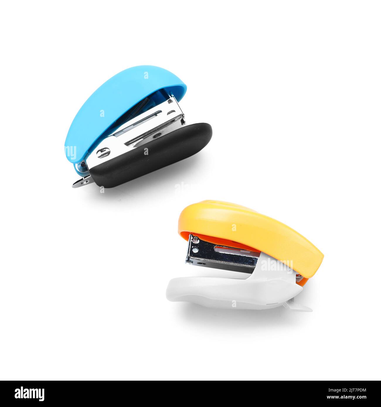 Two colorful staplers isolated on white background Stock Photo - Alamy