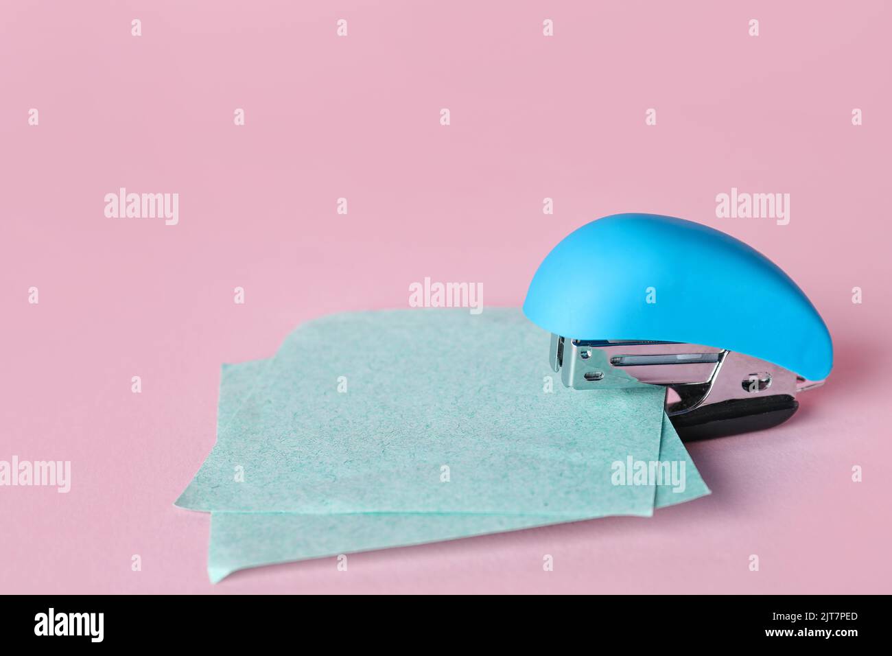 Stapler with sticky notes on pink background Stock Photo - Alamy