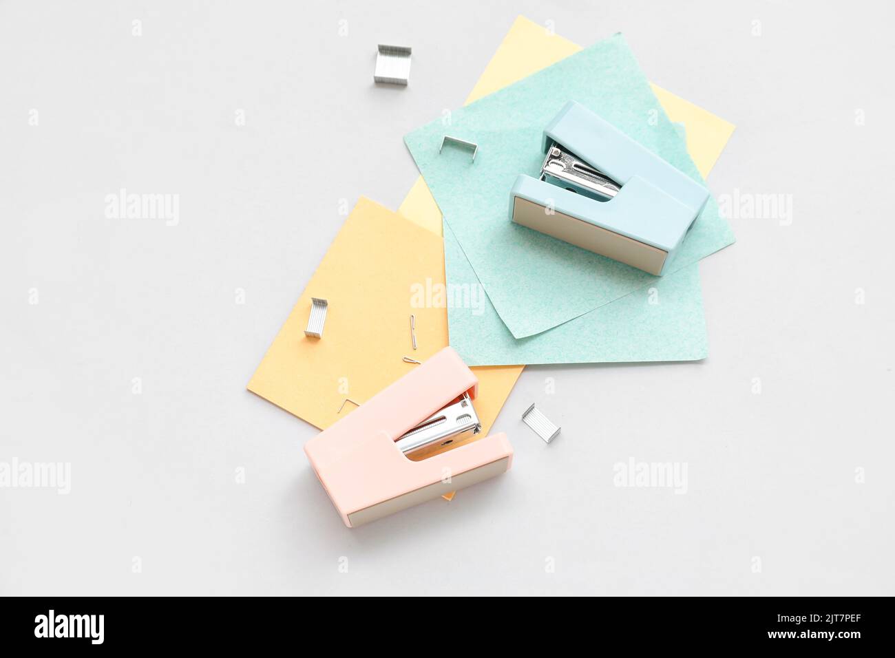 Staplers, sticky notes and staples on white background Stock Photo - Alamy