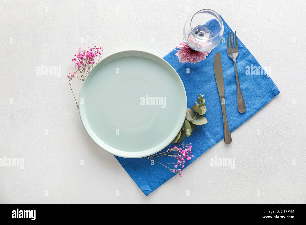 Simple table setting with floral decor on white background Stock Photo ...