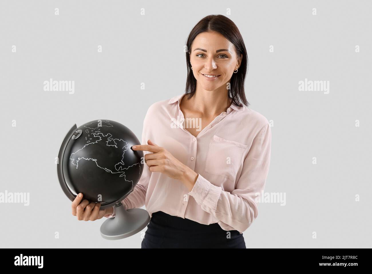 Female Geography teacher with globe on light background Stock Photo - Alamy