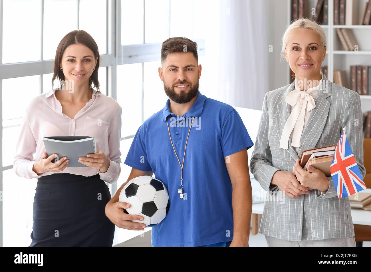 Different teachers working in school office Stock Photo - Alamy
