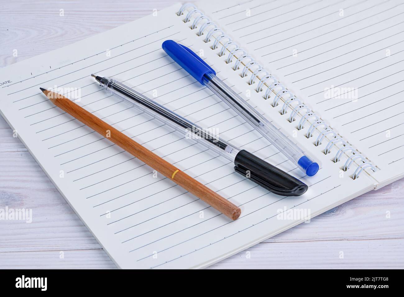 White notepad with lines and pencil and pens Stock Photo - Alamy