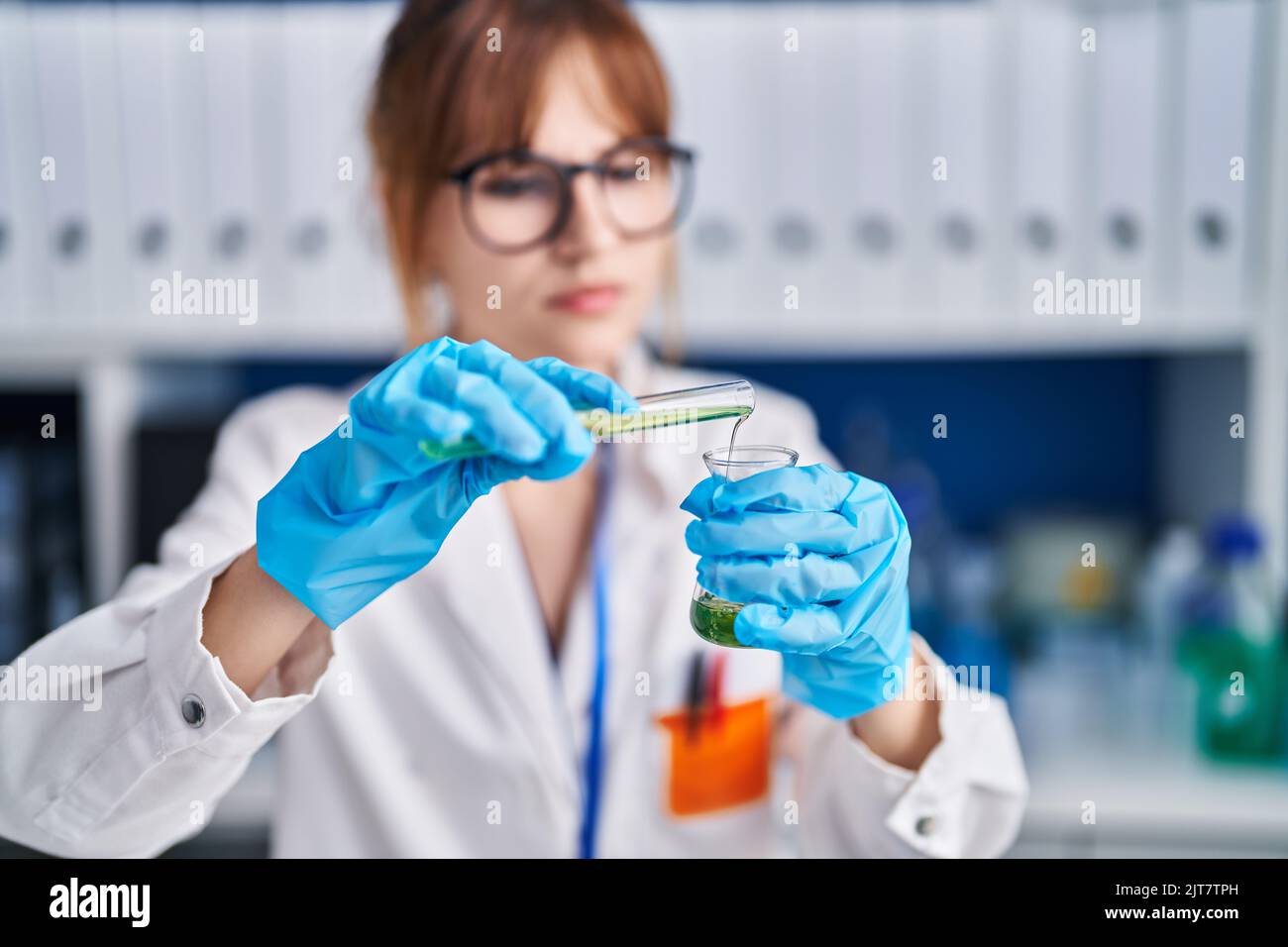 Young woman scientist measuring liquid at laboratory Stock Photo - Alamy