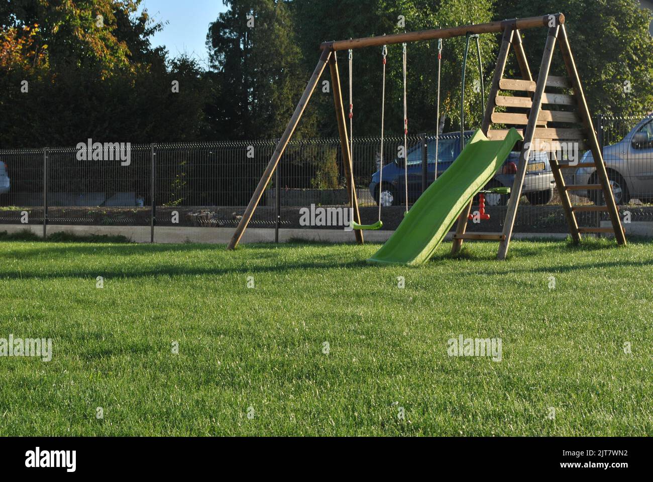 A slide for children in a green garden Stock Photo - Alamy